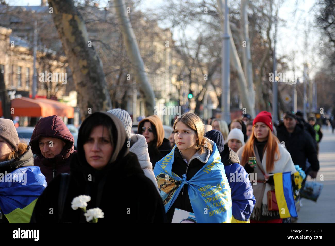 Participants of the commemorative procession walk along ...