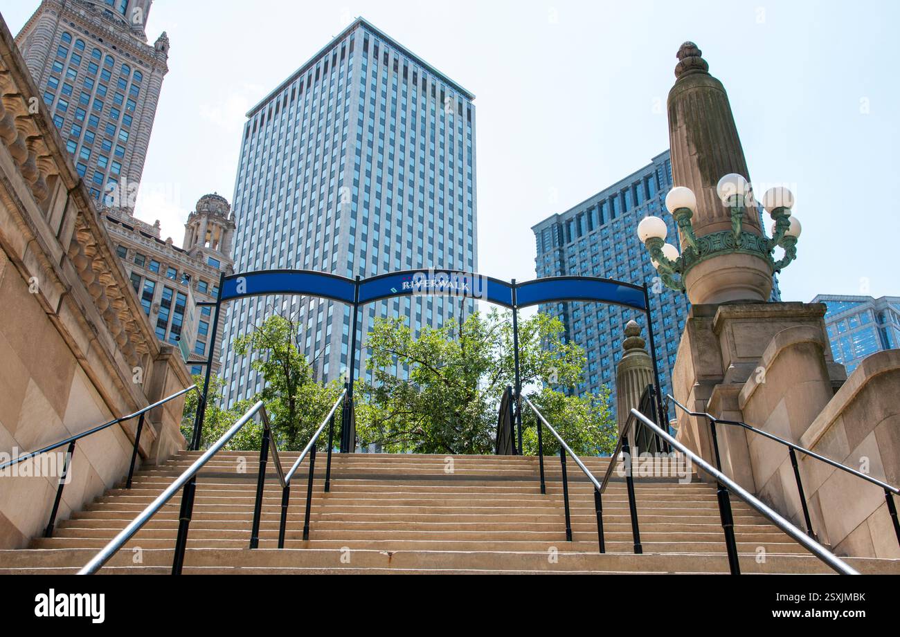 Steps lead to Riverwalk entrance surrounded by tall buildings on a ...