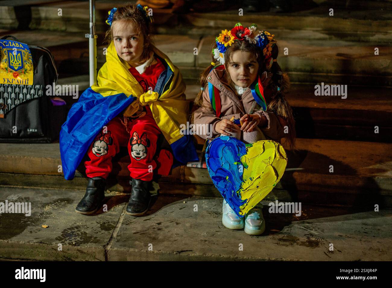 Two young Ukrainian girls wearing national head-dresses whilst wrapped ...
