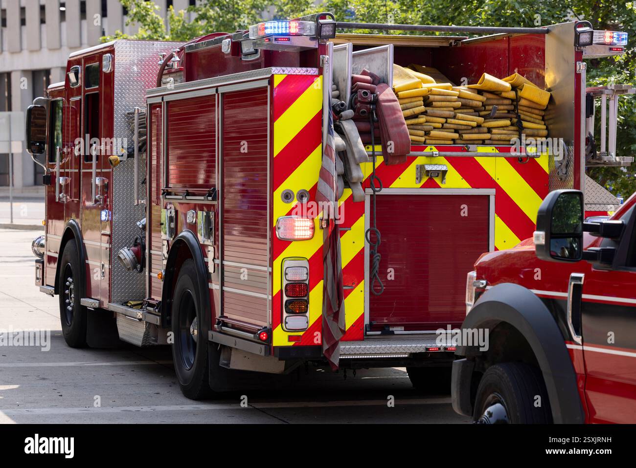 An ambulance and fire engine respond to an emergency on a city street ...