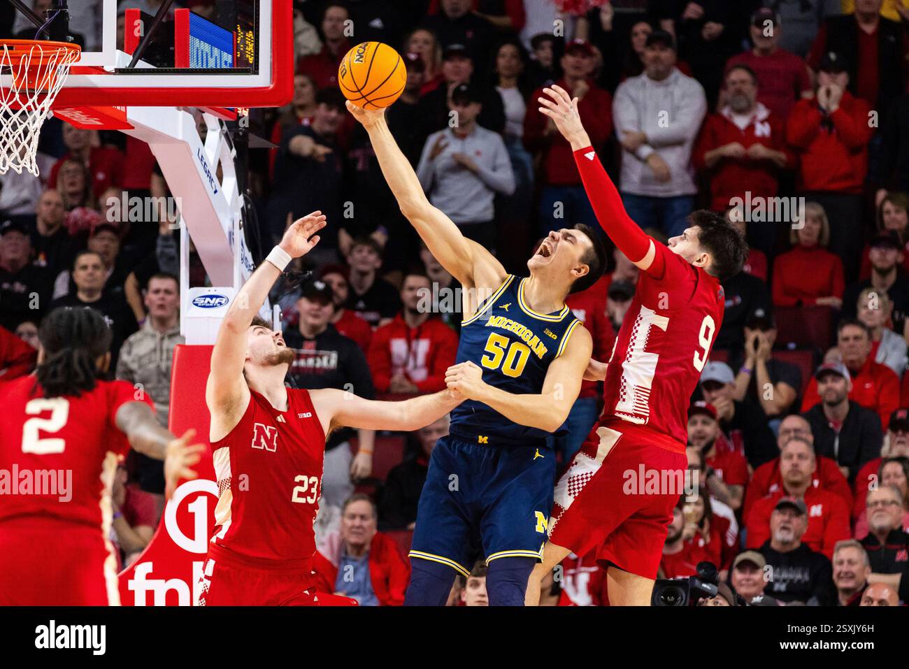 Michigan center Vladislav Goldin (50) grabs a rebound against Nebraska ...