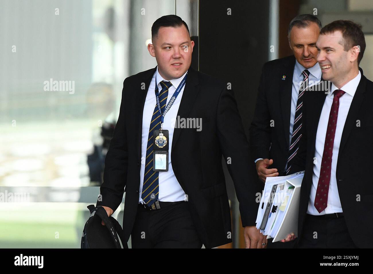 Queensland Police investigator Robert Lavallee (left) leaves Brisbane ...