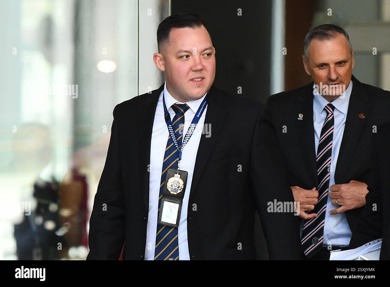 Queensland Police investigator Robert Lavallee (left) leaves Brisbane ...