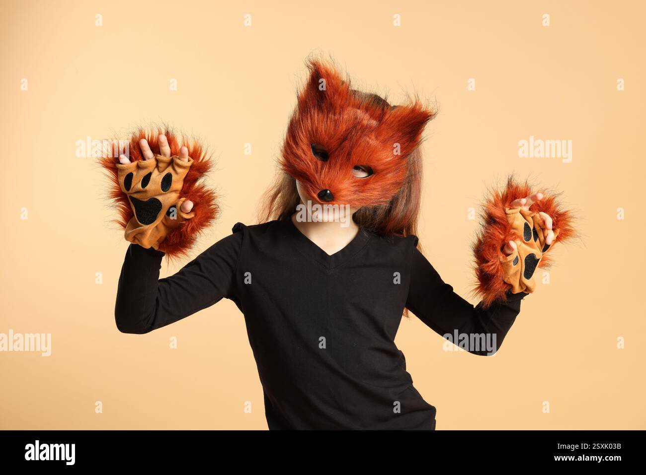Quadrobics. Girl wearing fox mask and gloves on beige background Stock ...