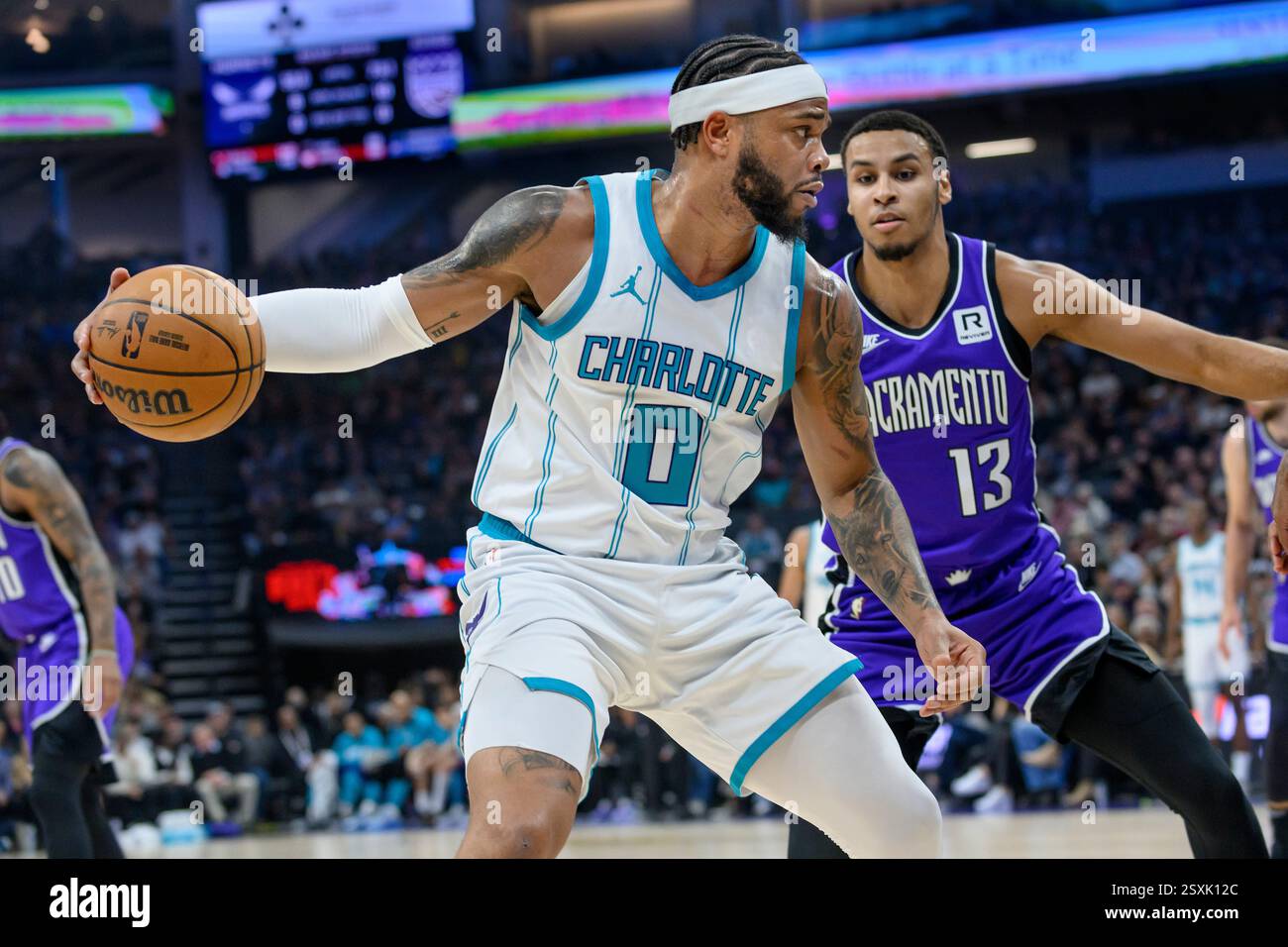 Charlotte Hornets forward Miles Bridges (0) is guarded by Sacramento ...