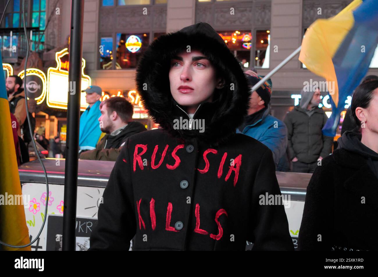 A pro-Ukraine demonstrator wears an outfit that says, "Russsia kills ...