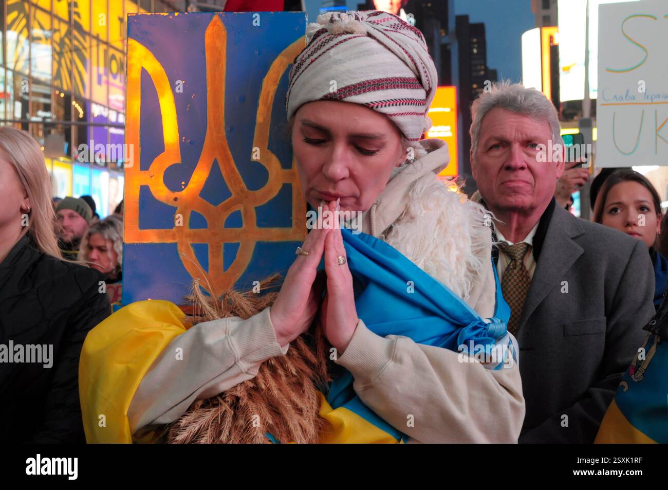 A pro-Ukraine demonstrator holds her hands together at a rally in Times ...
