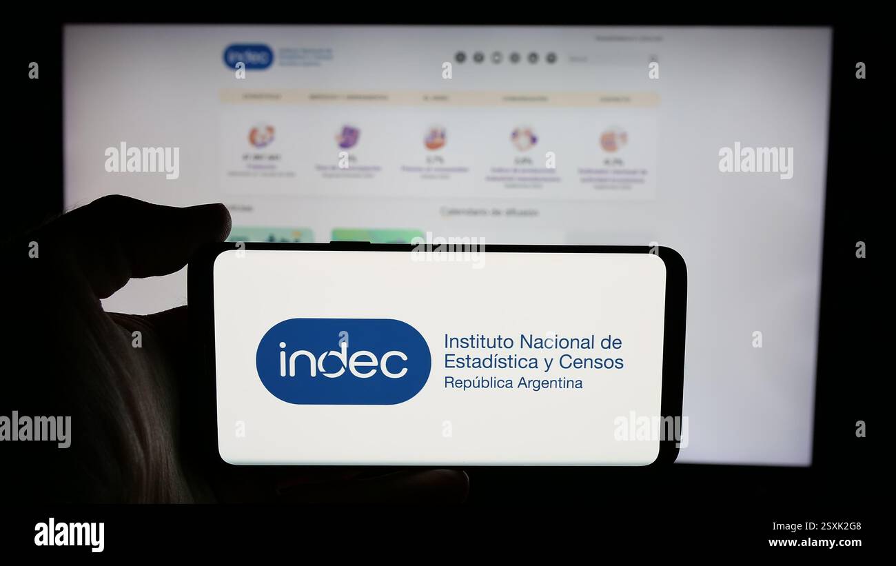 In this photo illustration, a person is holding a cellphone with the ...