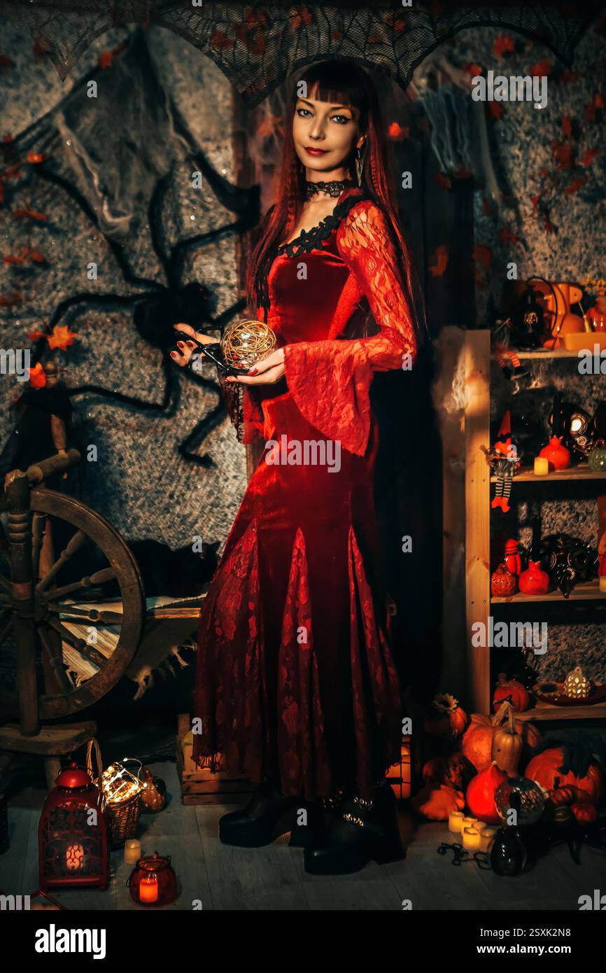Beautiful woman in a red dress in a mystical setting Stock Photo - Alamy