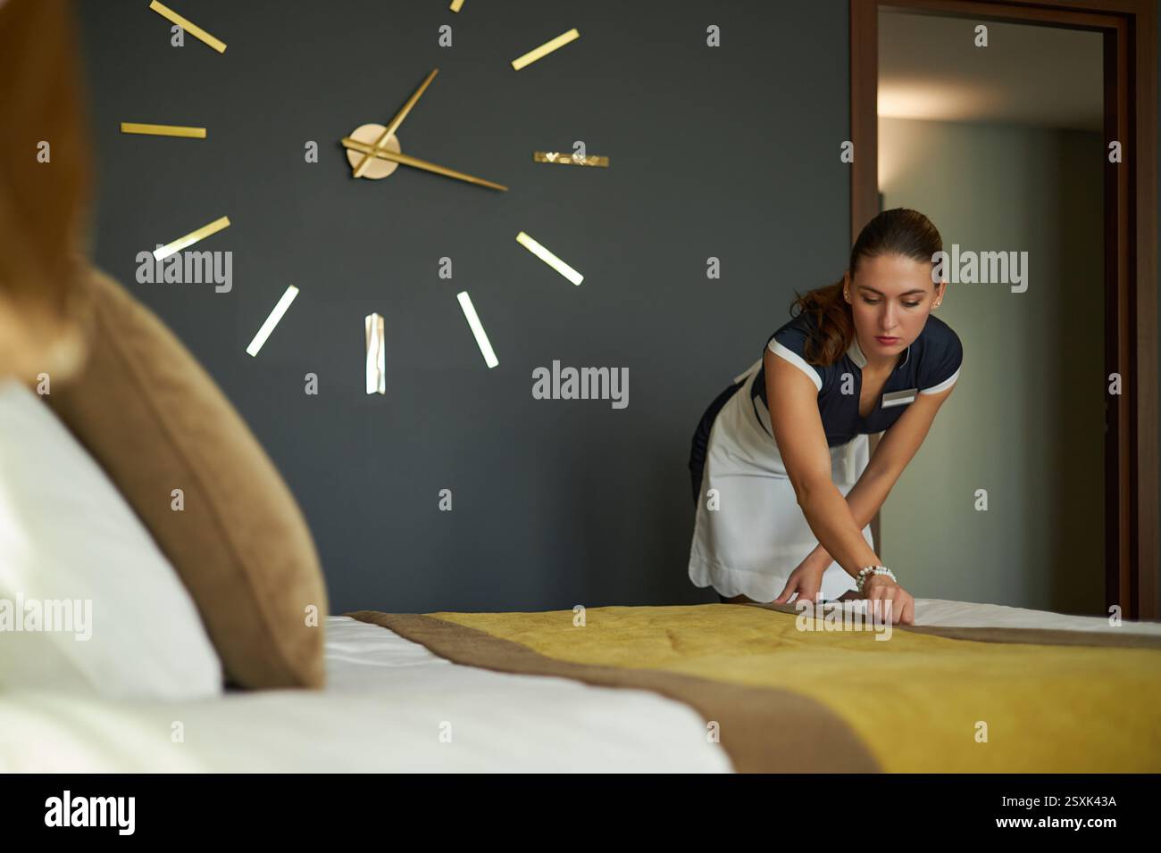Cleaning Hotel Room Bed with Care and Precision Stock Photo - Alamy