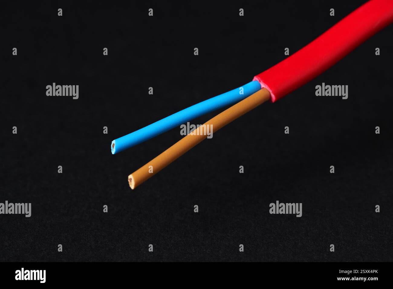 Red stripped electrical wire on black background, closeup Stock Photo ...