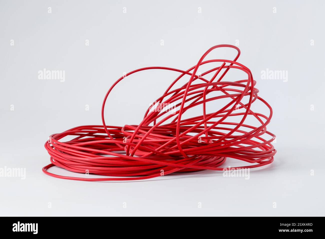 Insulated red electrical wire isolated on white Stock Photo - Alamy