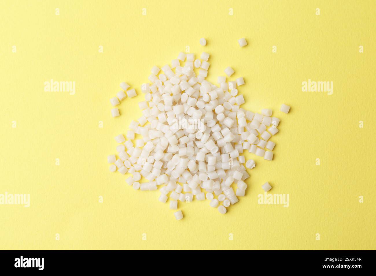 Pile of plastic granules on yellow background, top view Stock Photo - Alamy