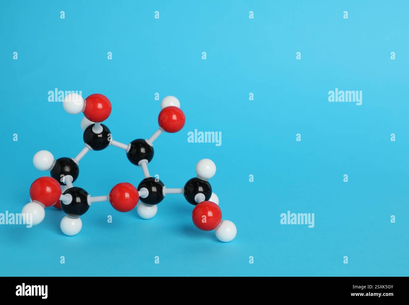 Molecule of glucose on light blue background, space for text. Chemical ...
