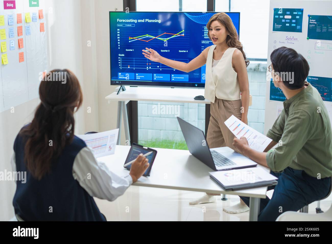 asian leader presenting a financial data and strategies in a modern ...