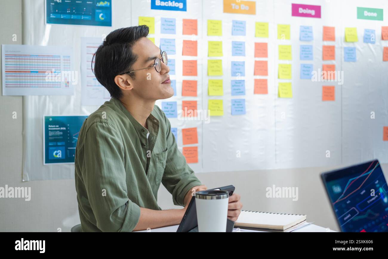 asian financial investor working in a office, analyzing financial ...