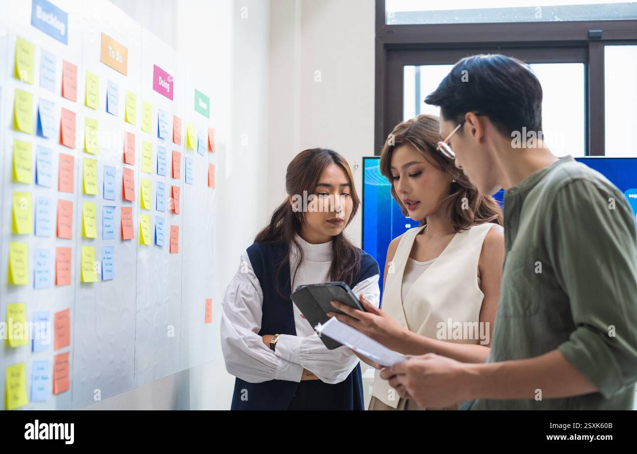 brainstorming session, using sticky notes on a task board (kanban) to ...
