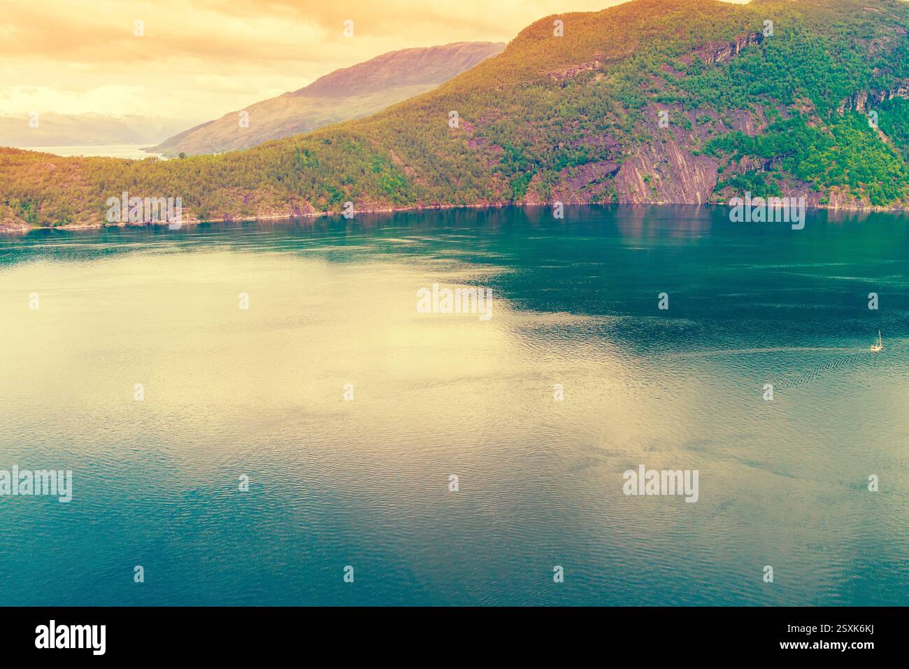 Fjord at sunset. Rocky coast in the evening. Hardanger Fjord. Beautiful ...