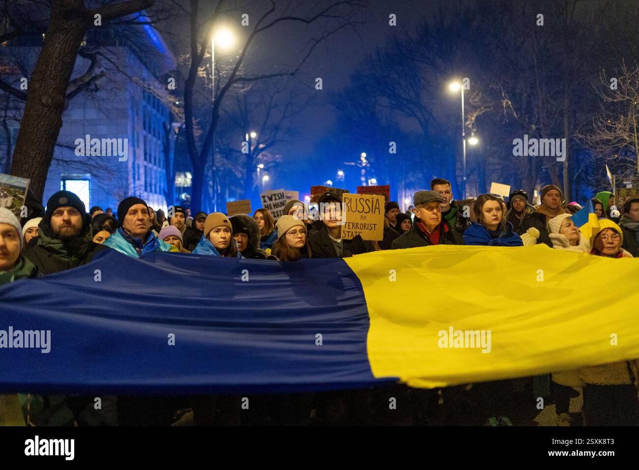 Warsaw, Poland. 24th Feb, 2025. Protesters shouting slogans hold a huge ...