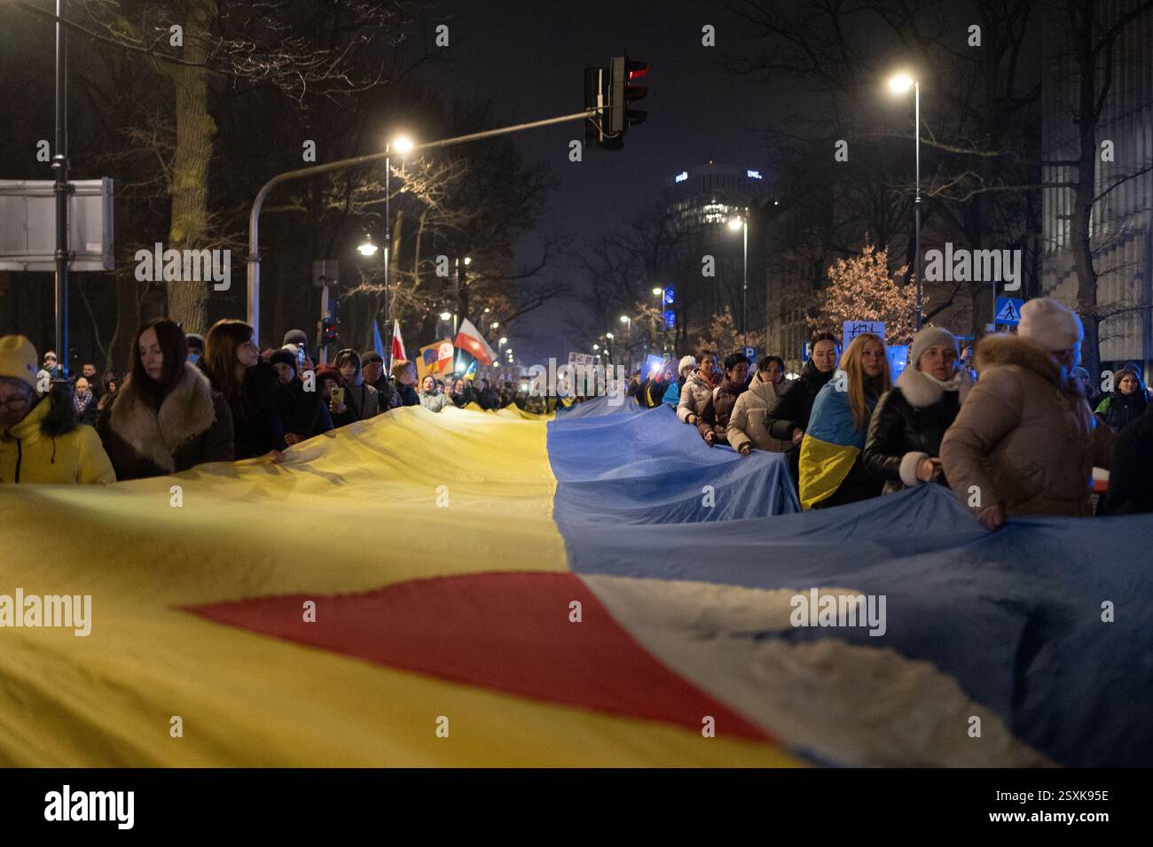 Warsaw, Poland. 24th Feb, 2025. Protesters shouting slogans hold a huge ...