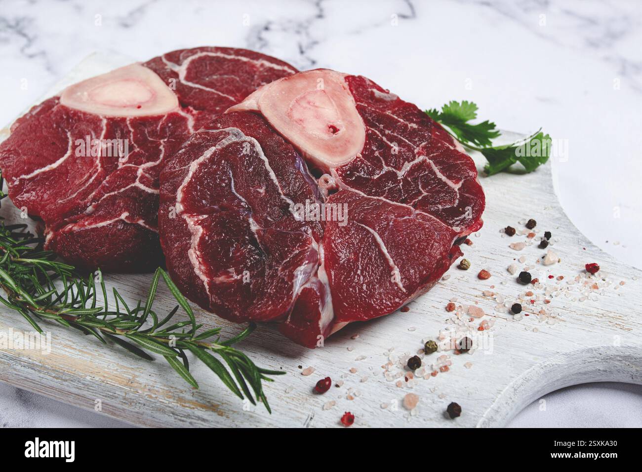 Knuckle on the bone, raw meat for ossobuco, on a wooden chopping board ...