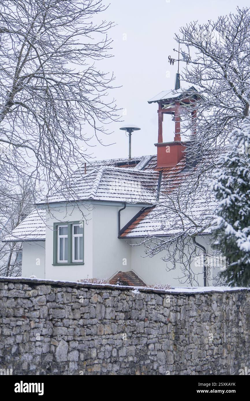 Traditional house with bell tower and wall in snowy winter, Aidlingen ...
