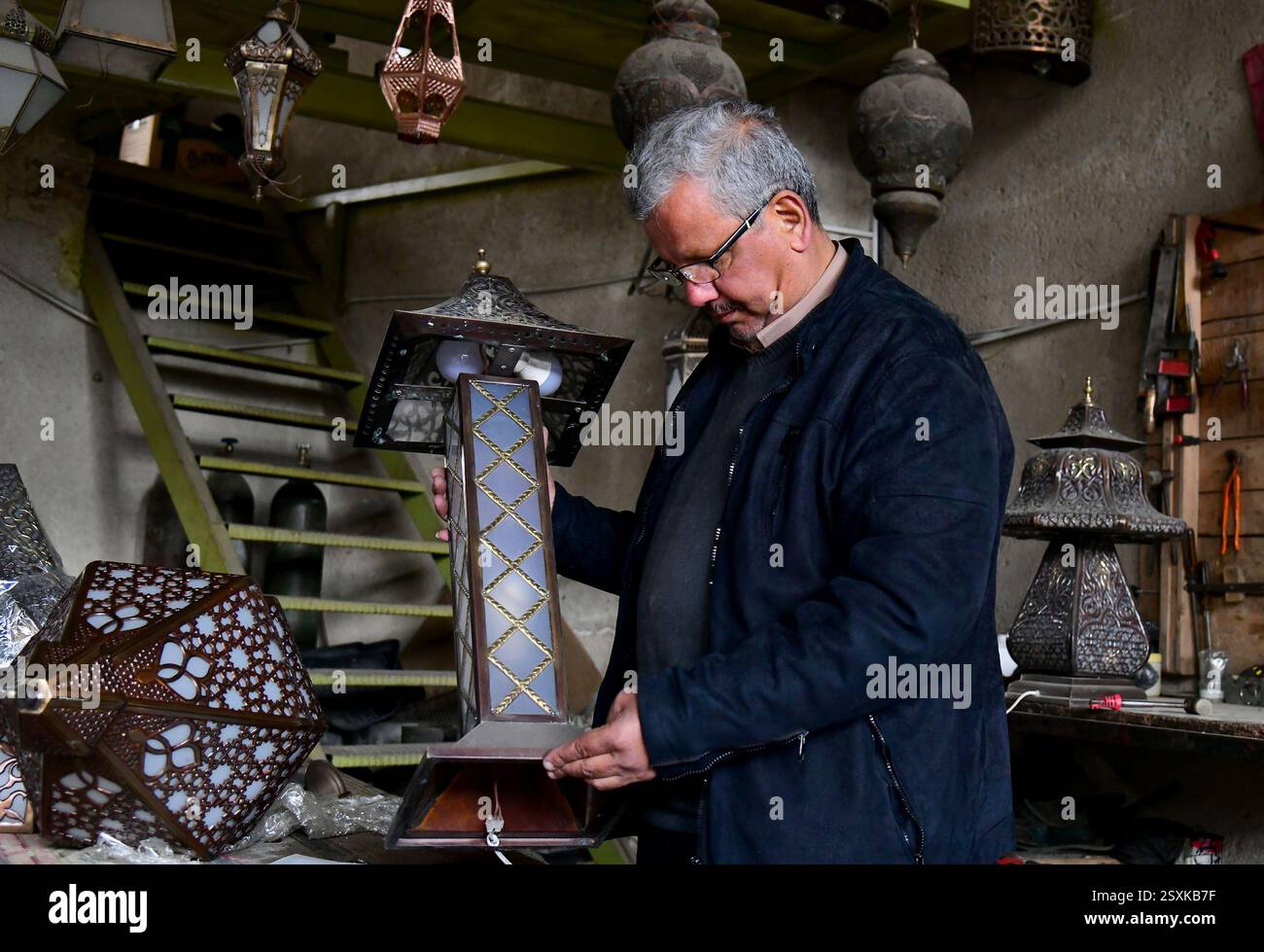 Damascus, Syria. 24th Feb, 2025. Craftsman Mohammad Al-Shayeb holds a traditional copper Ramadan ...