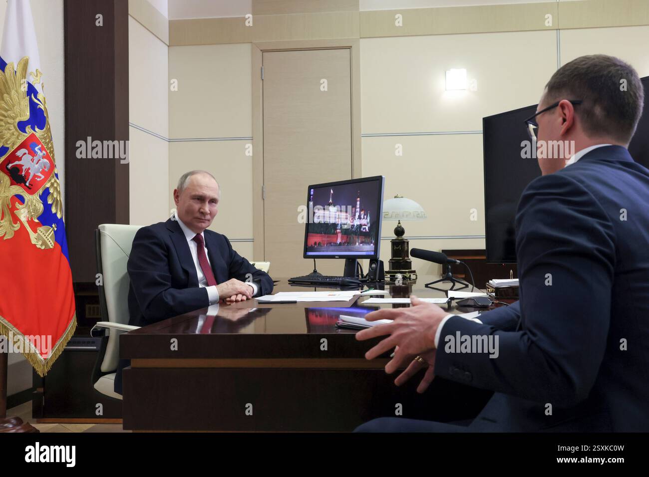 Russian President Vladimir Putin, left, speaks during his interview ...