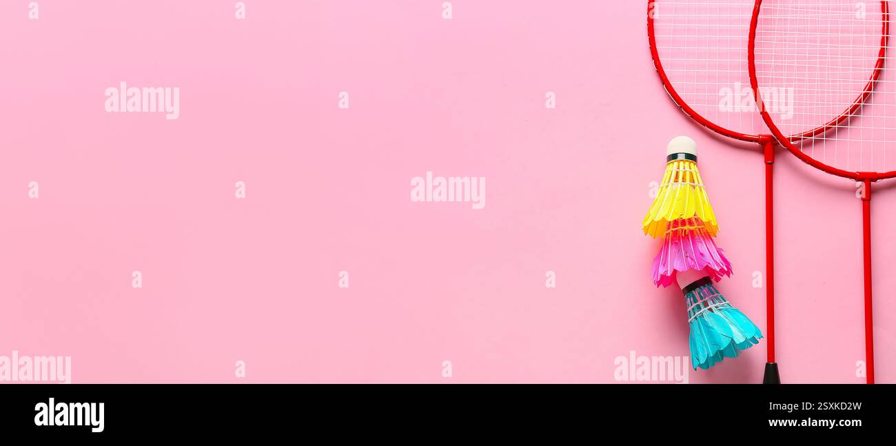 Badminton rackets and shuttlecocks on pink background with space for ...