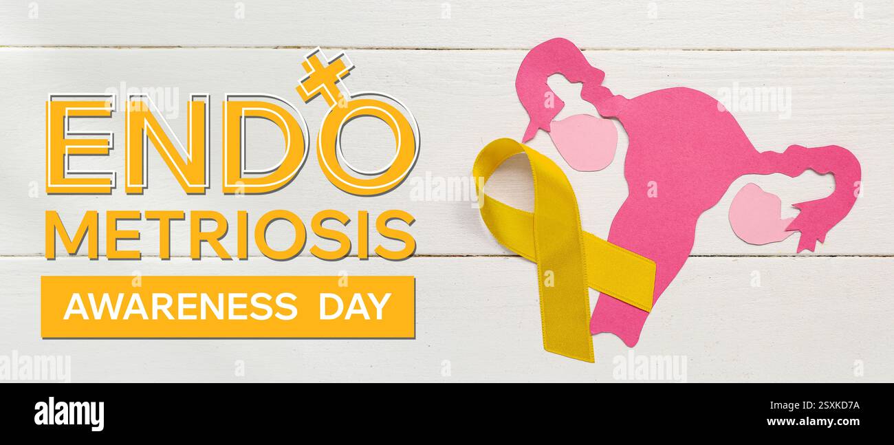 Yellow ribbon and paper uterus on white wooden background. Banner for ...