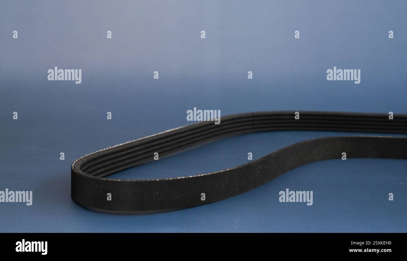 the car's generator belt. spare on a blue background Stock Photo - Alamy