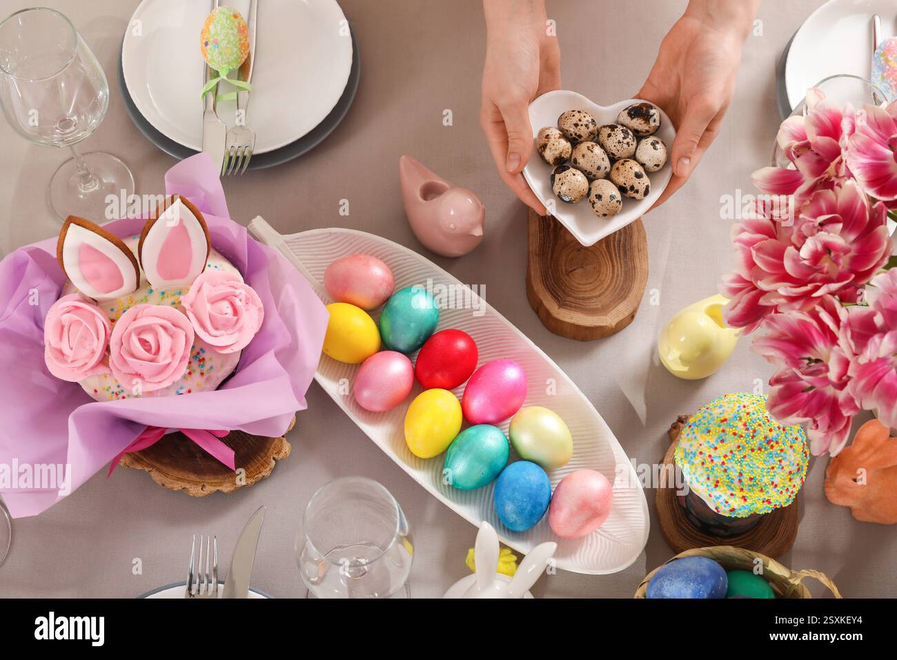Female hands decorating festive Easter table with bowl of eggs Stock ...