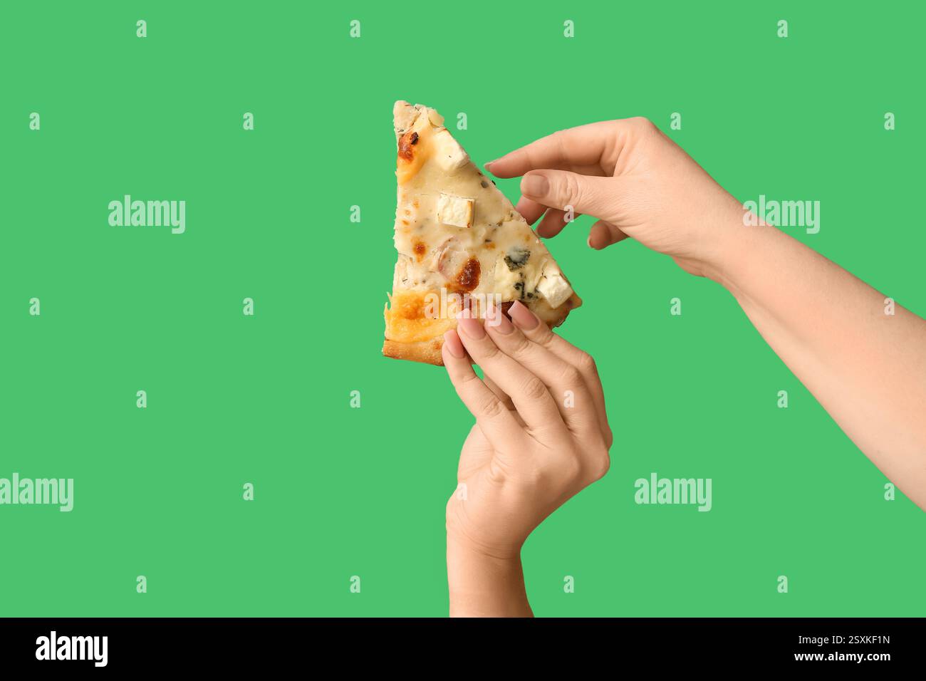 Female hand giving tasty pizza slice on green background Stock Photo ...