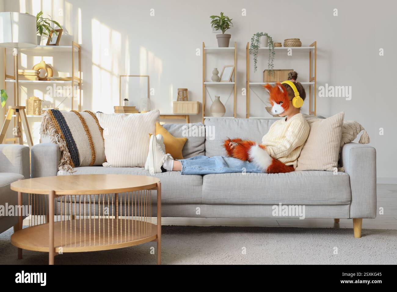 Quadrober girl in cat disguise listening to music at home Stock Photo ...