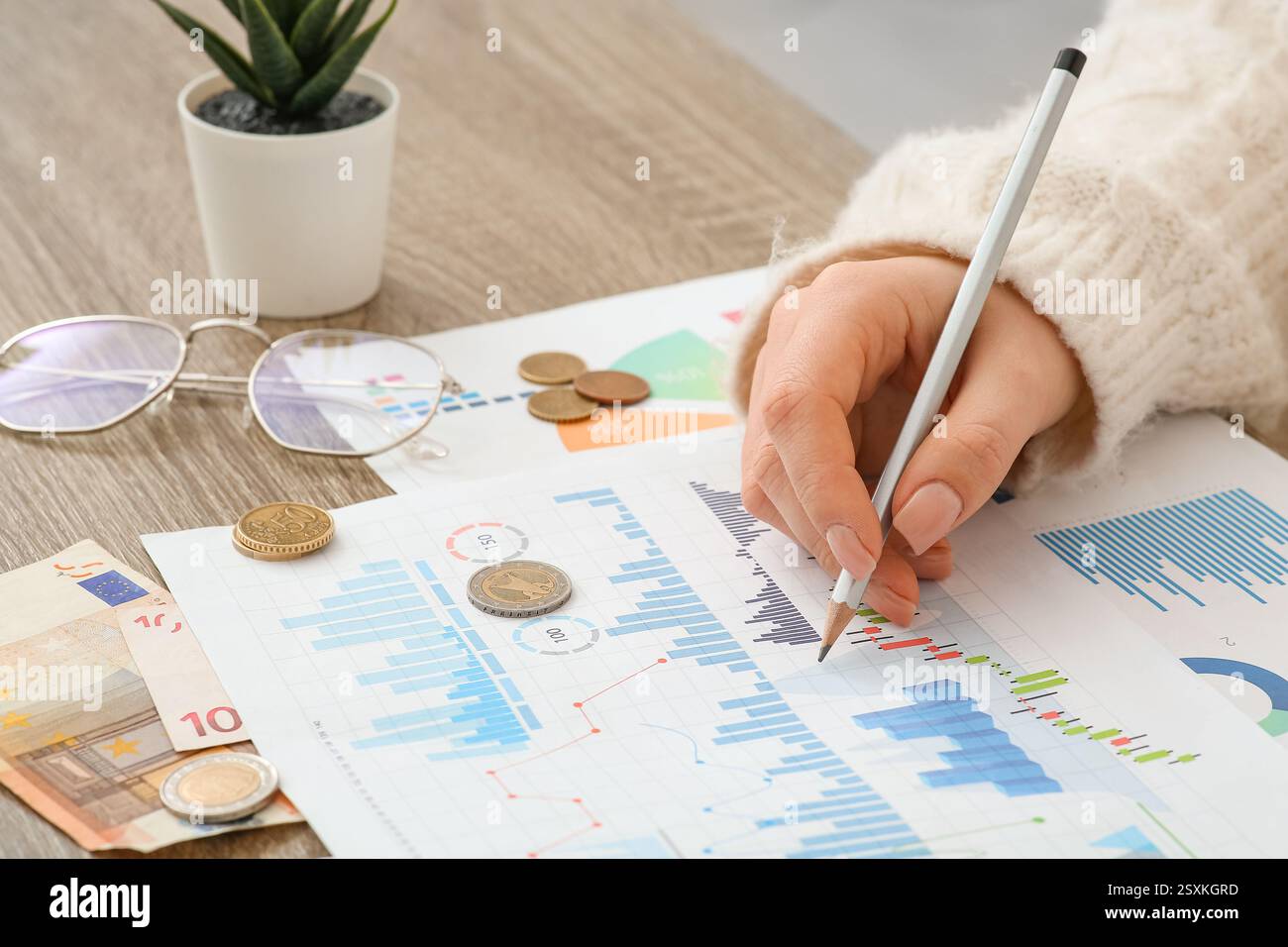 Woman with diagrams at table, closeup. Financial Wellness Month Stock ...