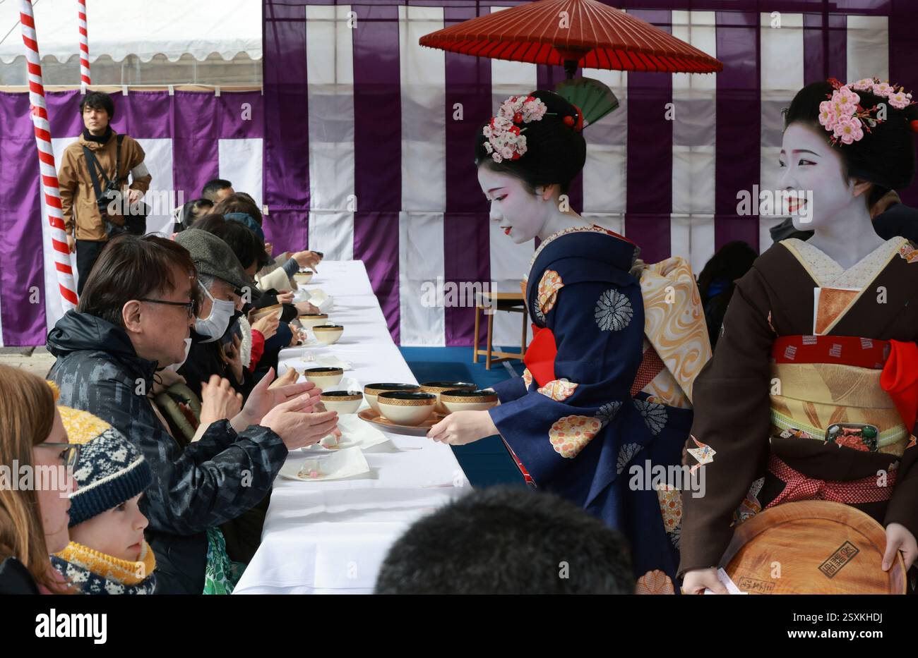 Geisha and maiko serve Matcha, powdered green tea, to worshipers under ...