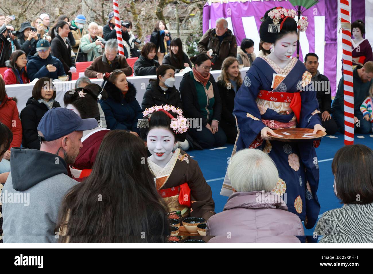 Geisha and maiko serve Matcha, powdered green tea, to worshipers under ...