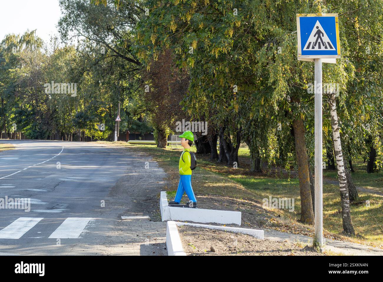 A pedestrian crossing with a plastic child safety figure near a road ...