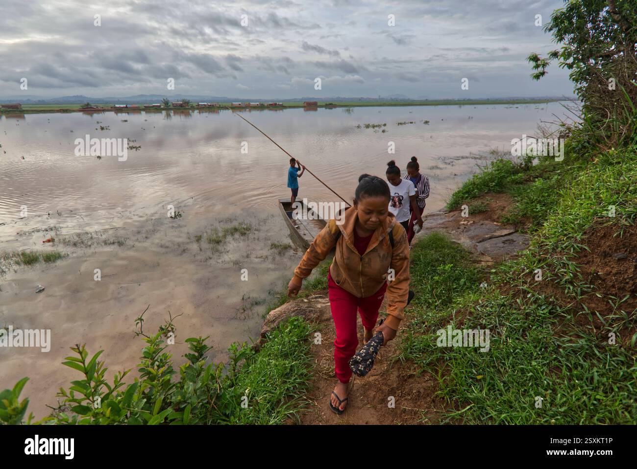 Flooding hits Madagascar Women on their way to work in Antananarivo ...