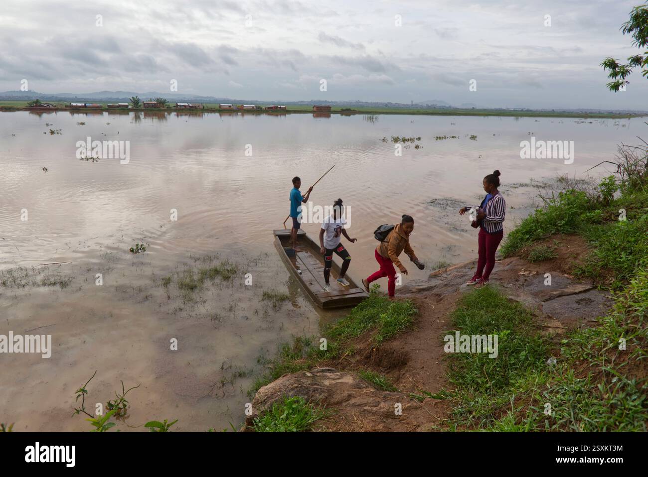 Flooding hits Madagascar A group of women wade through the flooded ...