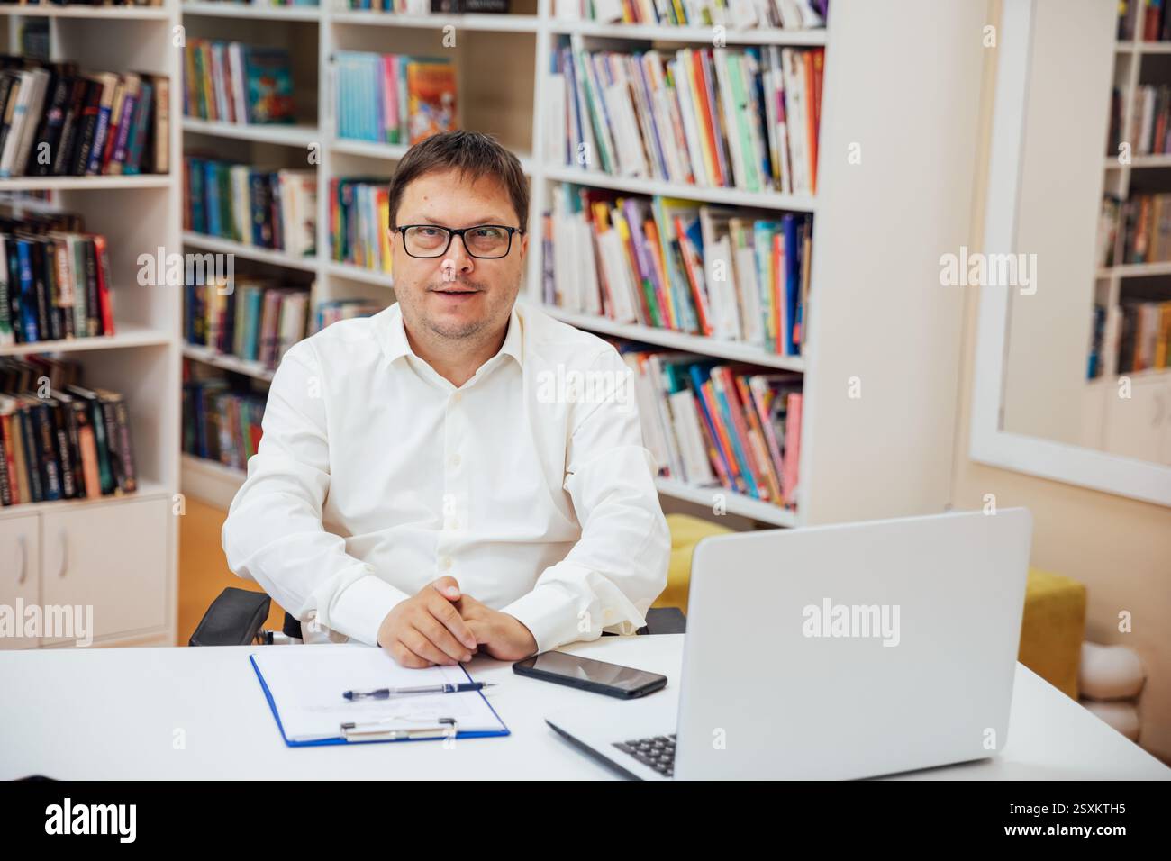 man studying at desk with laptop and books negotiating in office online ...