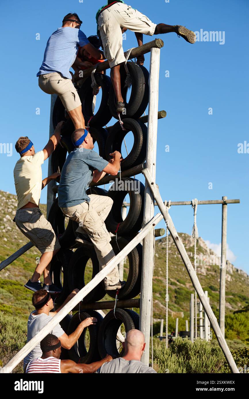Men, obstacles or climbing in bootcamp for training, army challenge or ...
