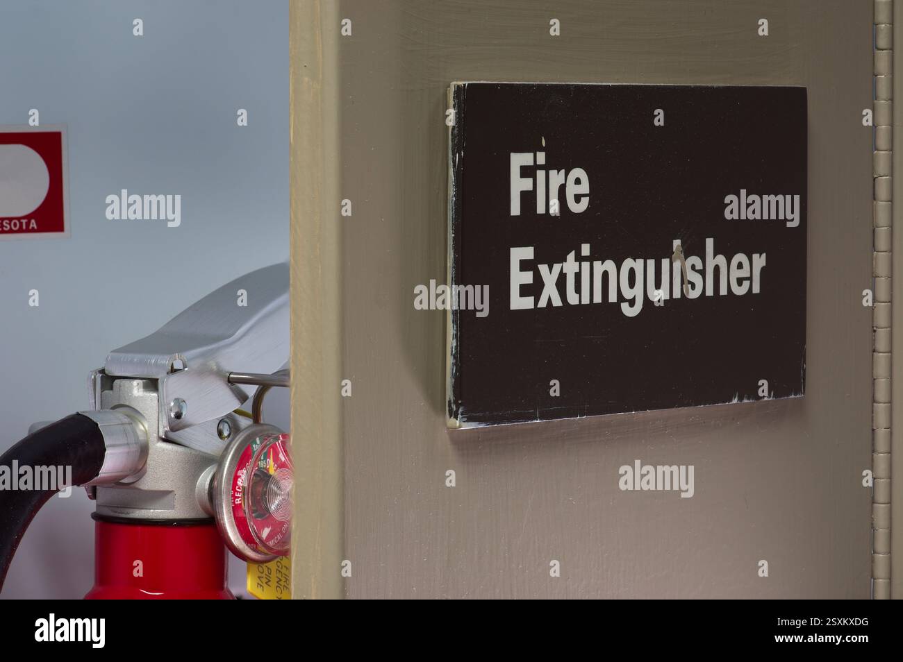 Fire extinguisher door slightly open with nozzle visible Stock Photo ...
