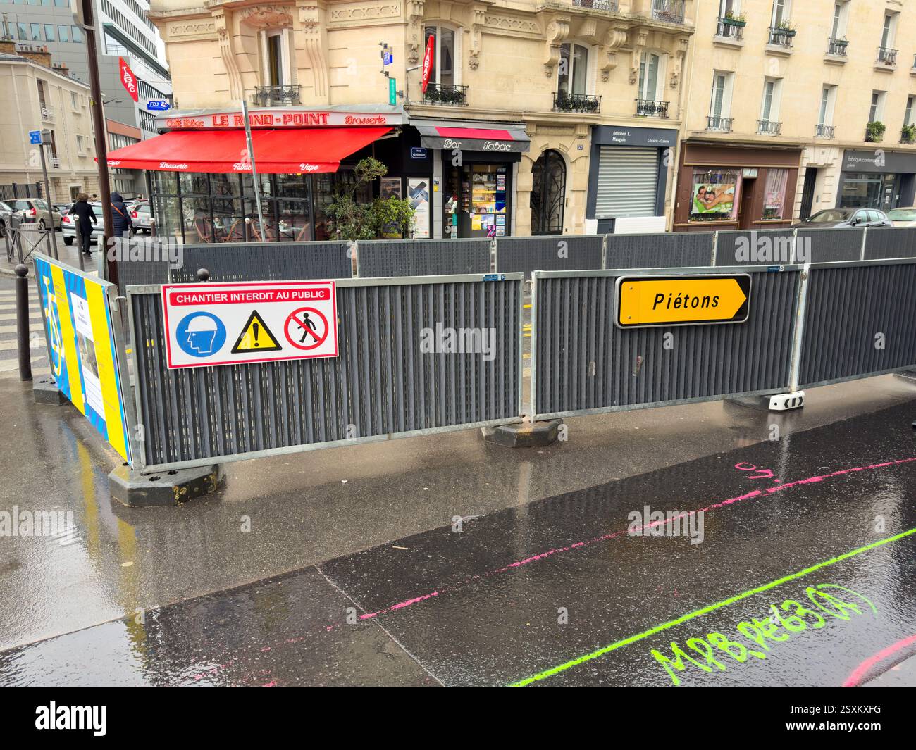 Construction barriers at a busy Paris intersection on a rainy day Stock ...