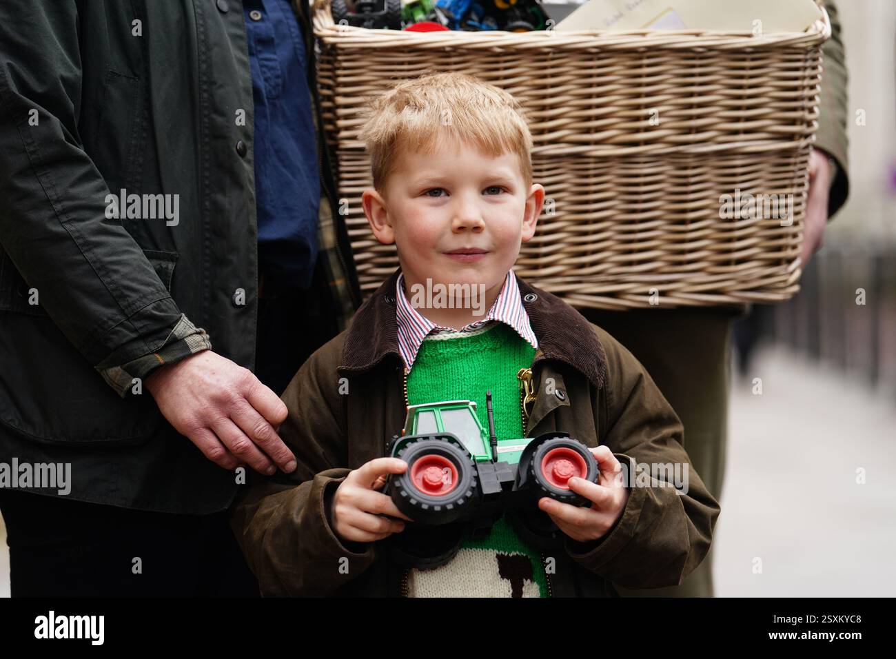 Five-year-old Bertie Church and his family protest outside the Treasury ...