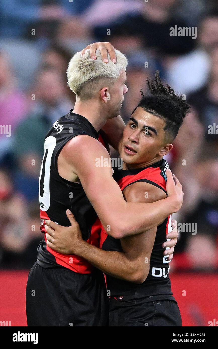 Geelong, Australia. 25th Feb, 2025. Isaac Kako of Essendon (right ...