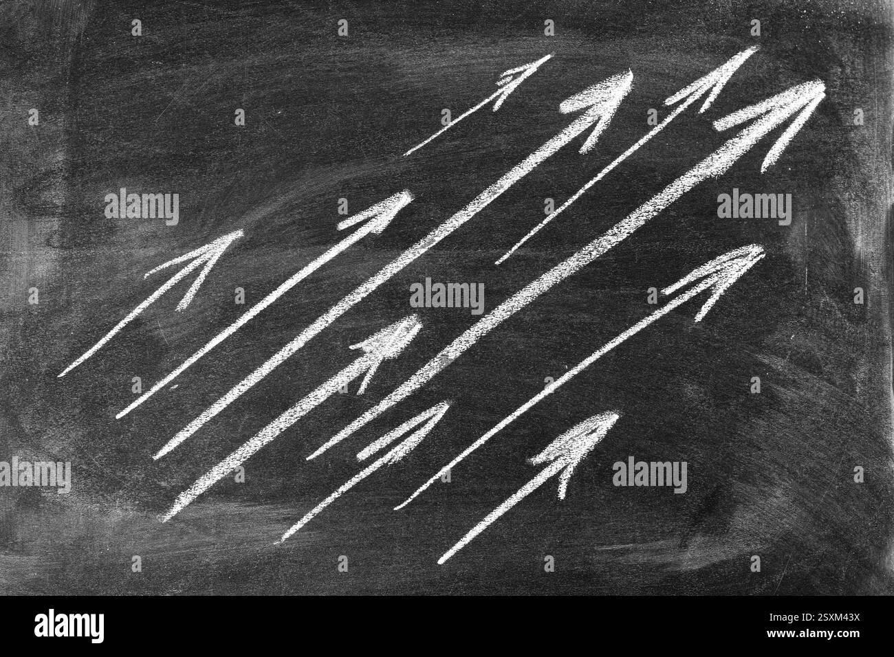 White chalk drawing of various arrows on black grunge background with ...