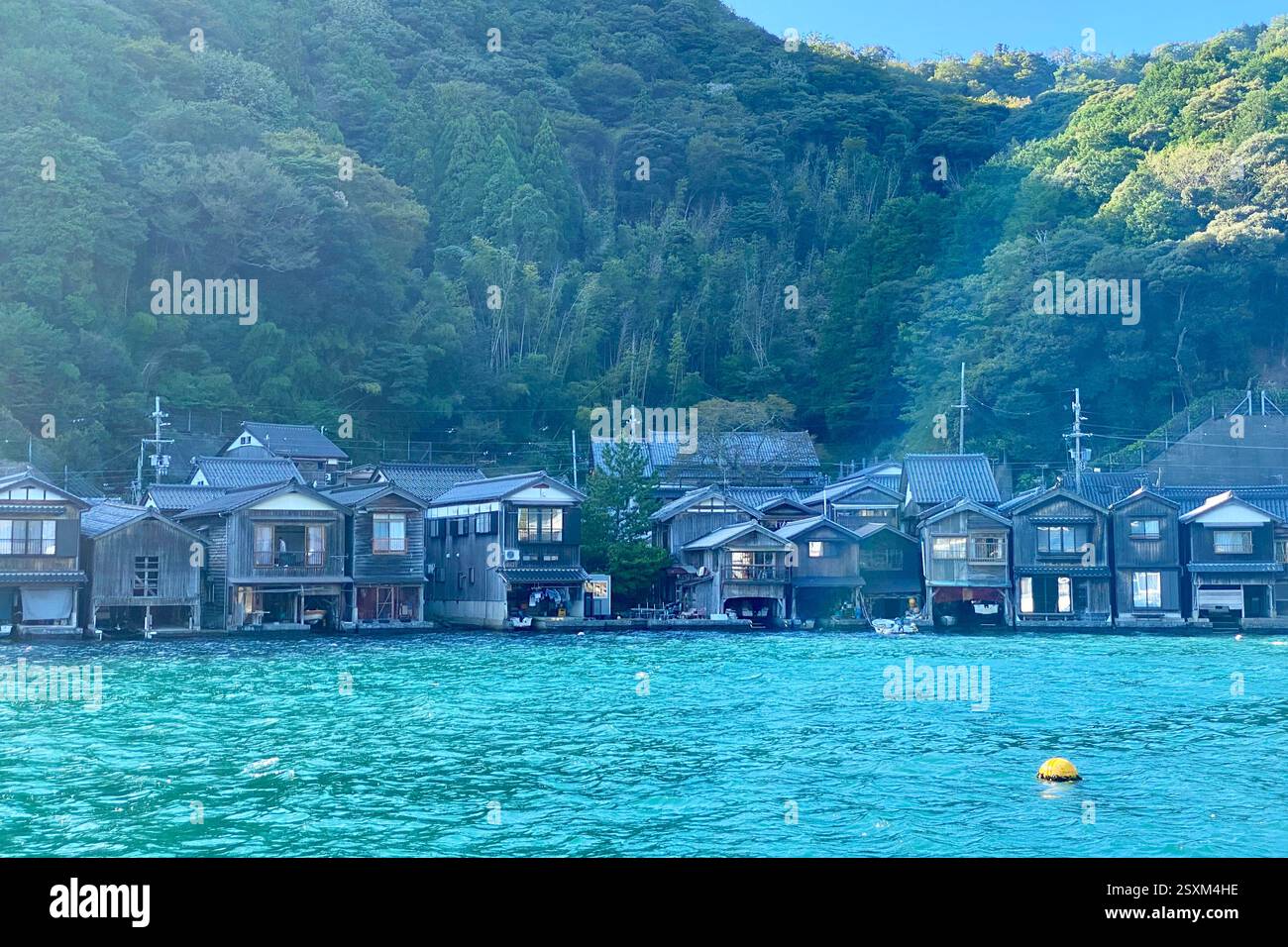 The old wooden houses in the shore of a blue sea in Ine city in Japan ...