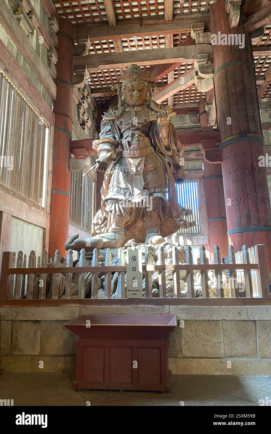 The guardian of the temple sculptured in wood Stock Photo - Alamy