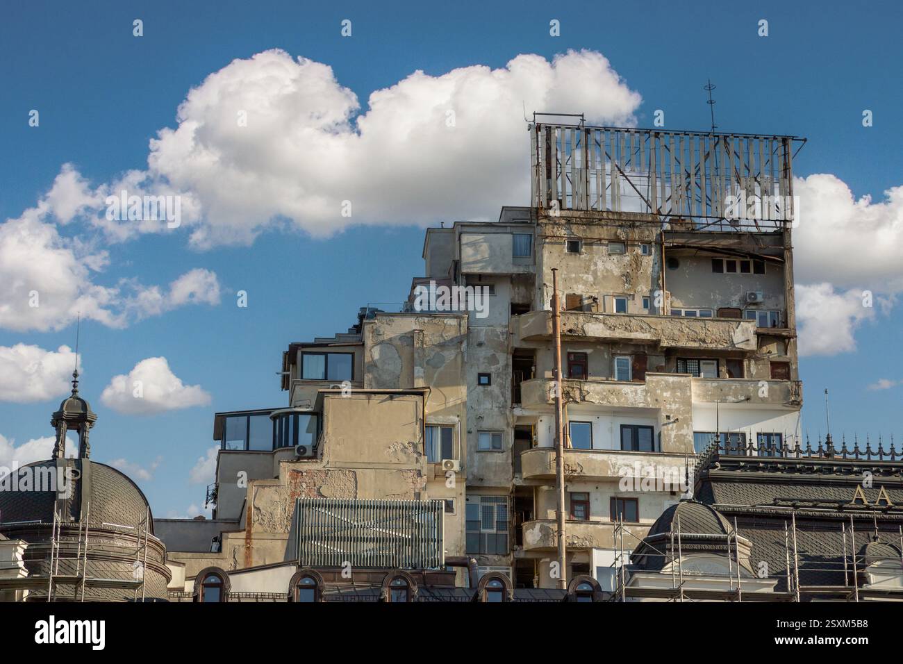 A weathered building showcasing various architectural styles stands ...